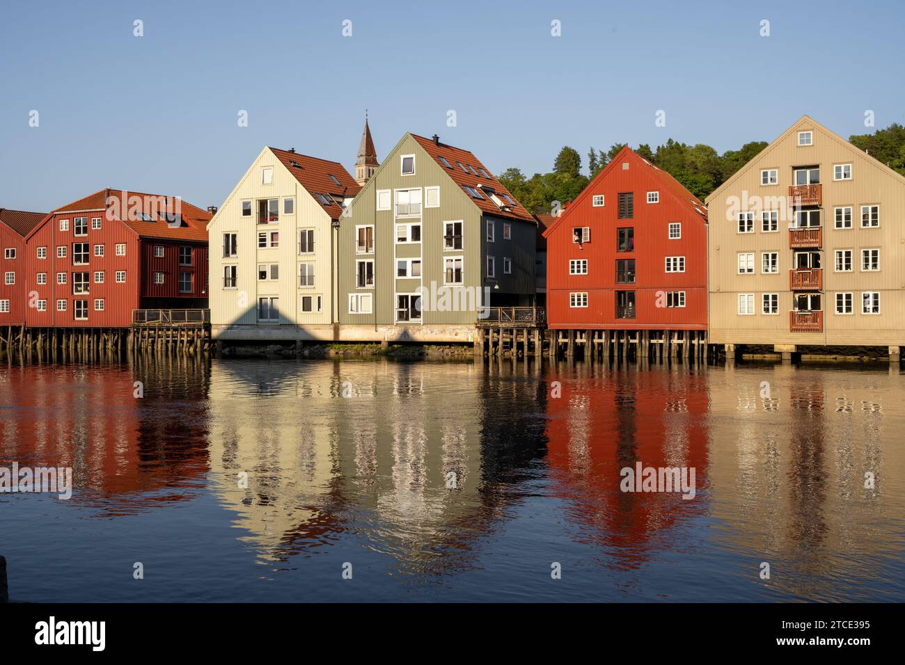 Beautiful buildings of Bryggen reflected in the waters of the Nidelva ...