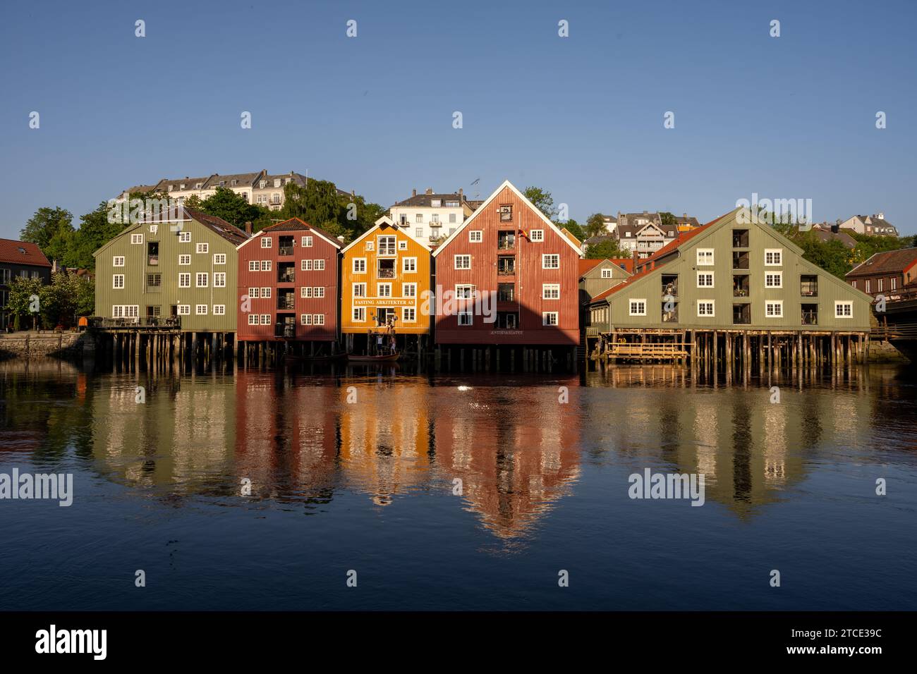 Beautiful of buildings of Bryggen, Trondheim, lit by the late sun and ...