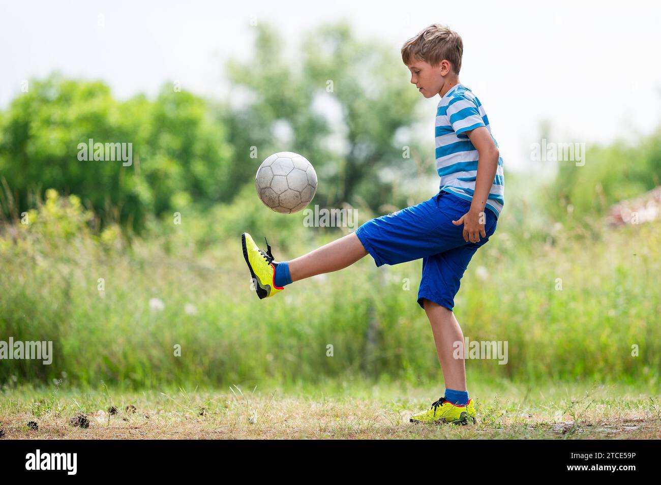 Young boy during exercises football Stock Photo - Alamy