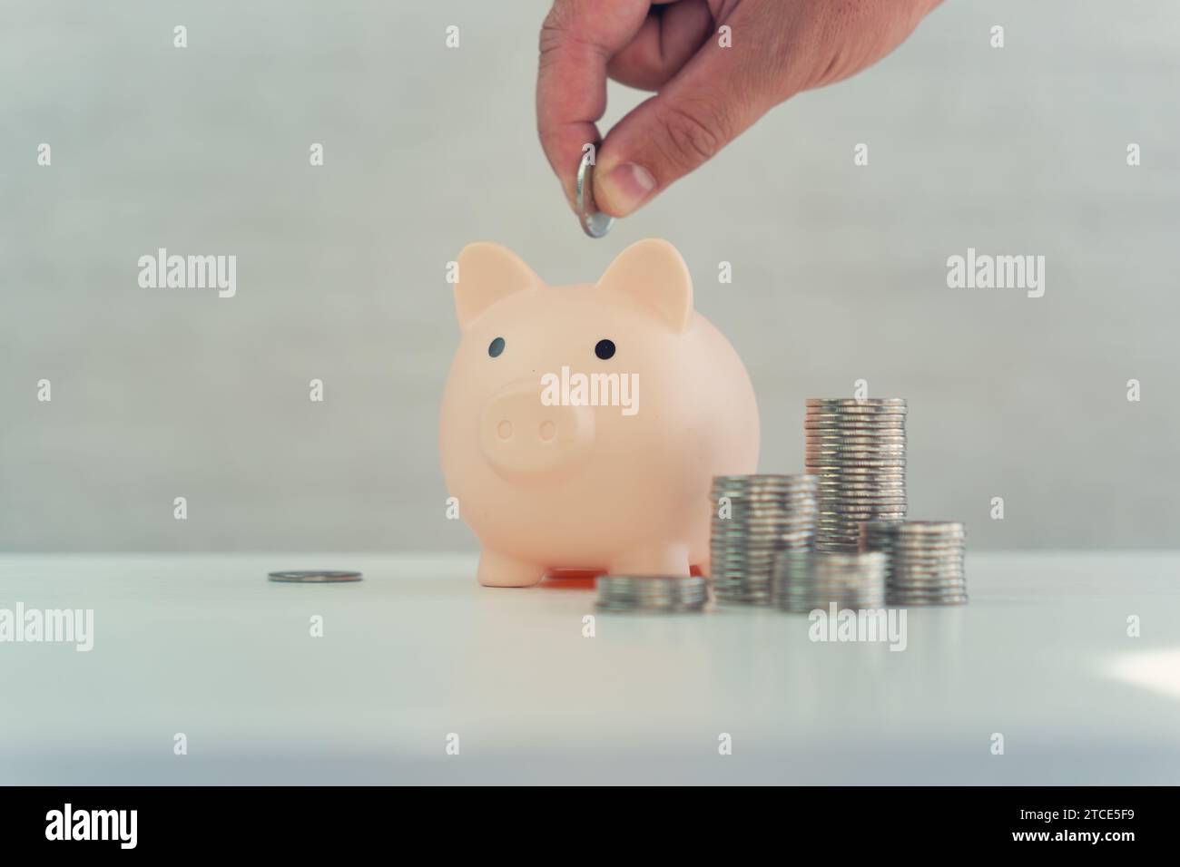 Cute piggy bank, pink color with piles of coins isolated on white ...