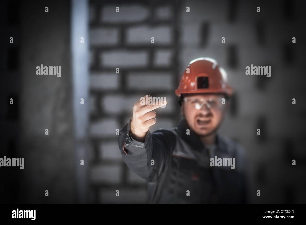 Portrait of an angry worker at a construction site, demands for ...