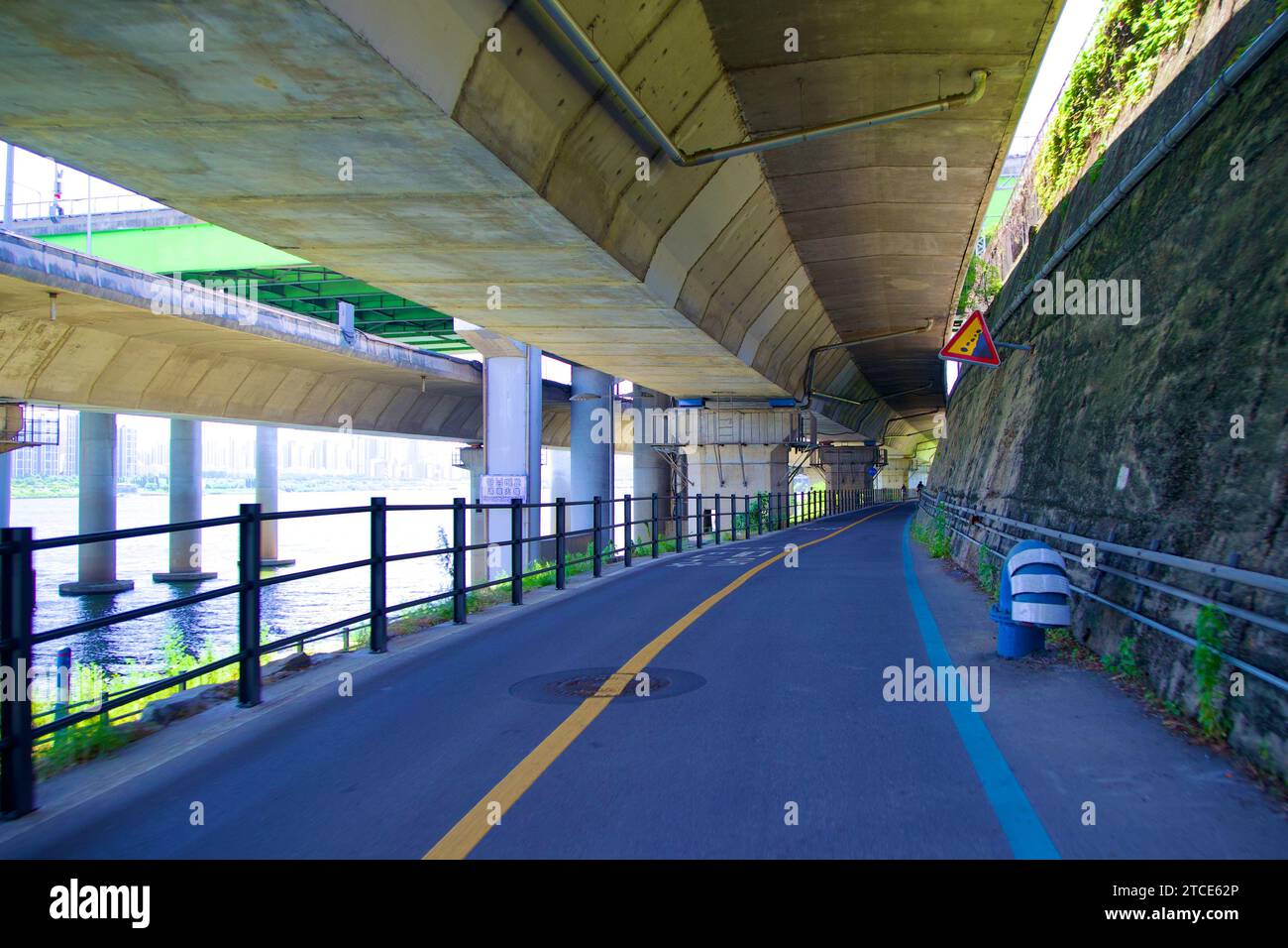 This unique bike path, nestled under a low-hanging expressway, hugs a ...