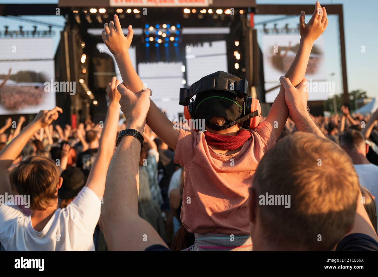Applause of a boy with headphones during music concert Stock Photo - Alamy
