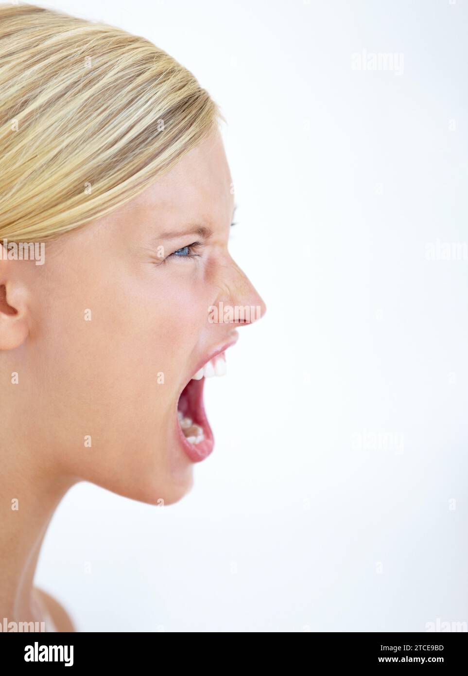 Angry face, profile or woman screaming in studio at mockup space for ...