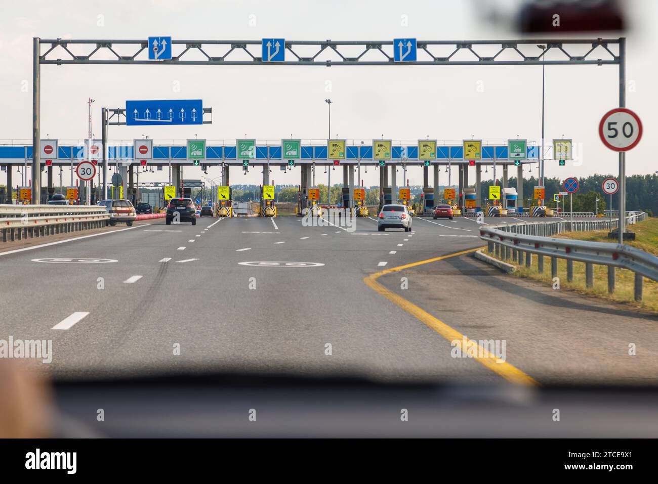 cars approaching to checkpoint on toll road, view from inside a car ...
