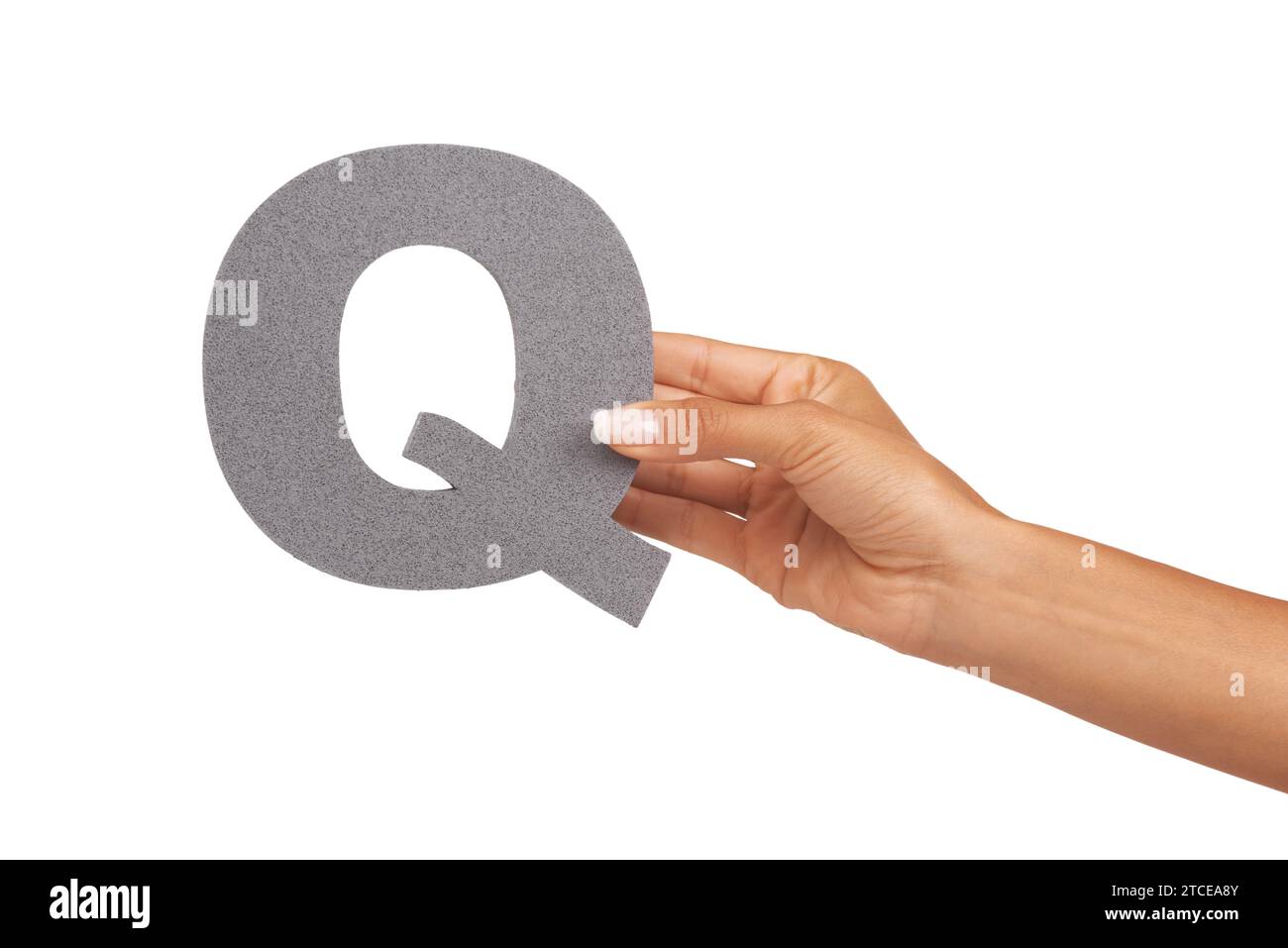 Hand, capital letter and spelling q in studio and education or alphabet ...
