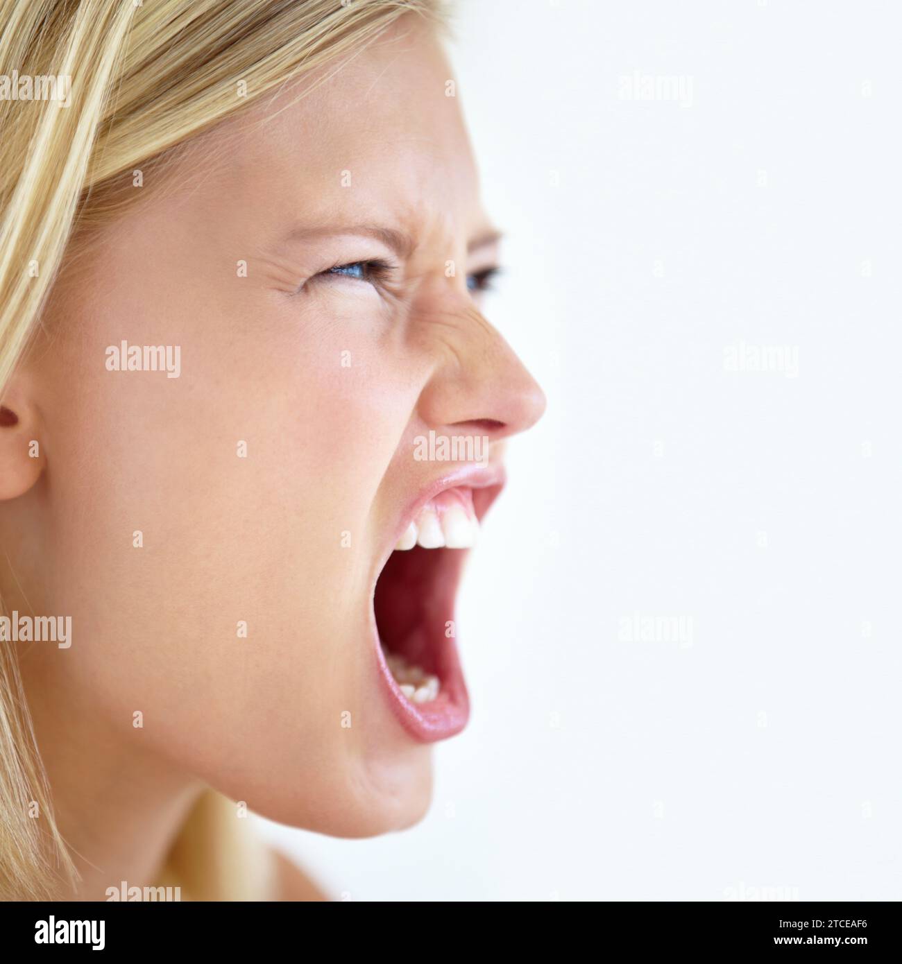 Angry, face or woman screaming in studio at mockup space for crisis ...