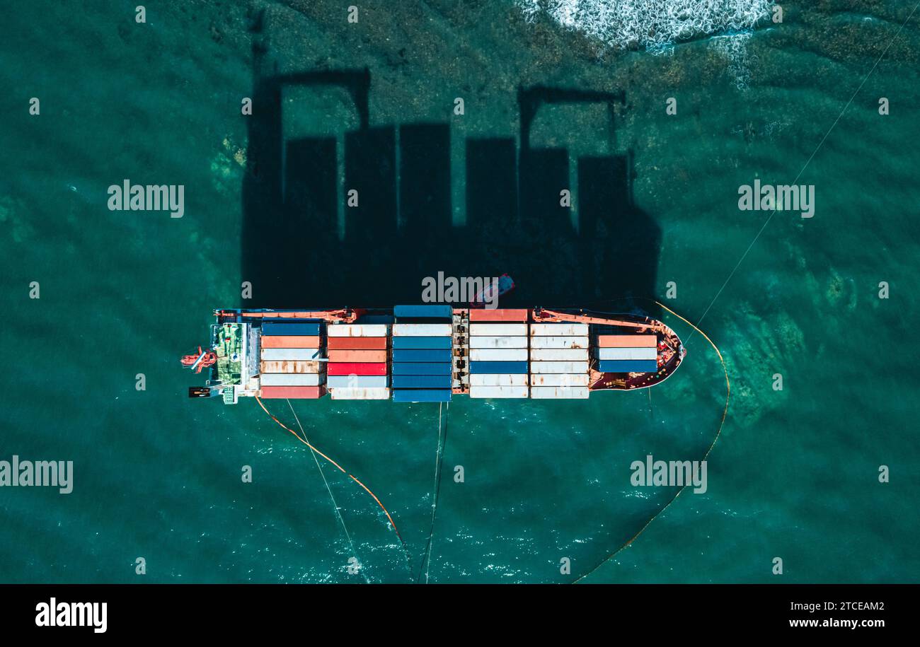 Aerial top down view of a container cargo ship stands aground after a ...