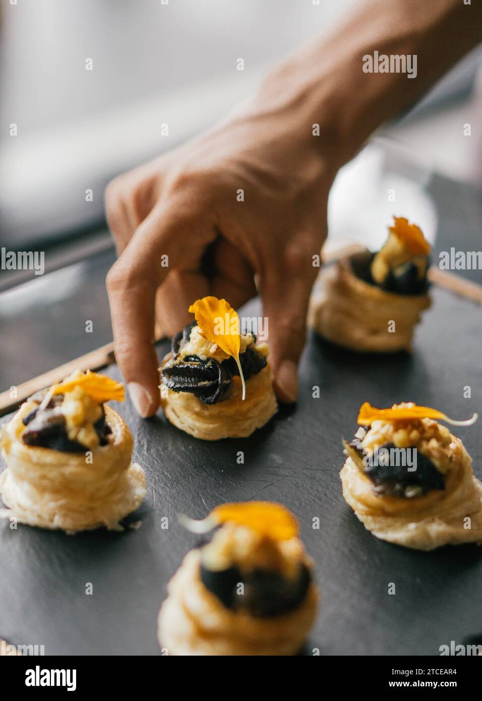 a person's hand picking up a very delicious food with savory texture ...