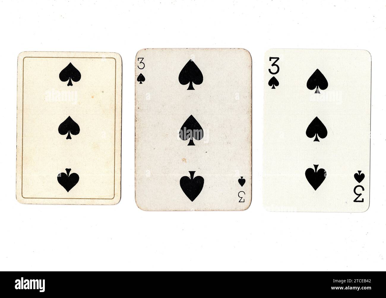Three three of spades vintage/antique playing cards in various designs ...