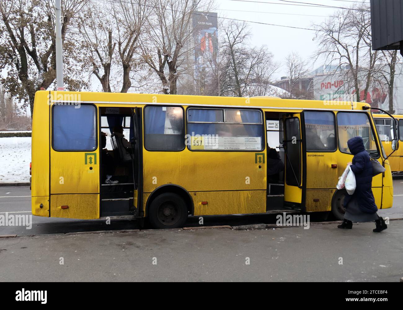 KYIV, UKRAINE - DECEMBER 12, 2023 - A woman gets on a shared taxi as ...