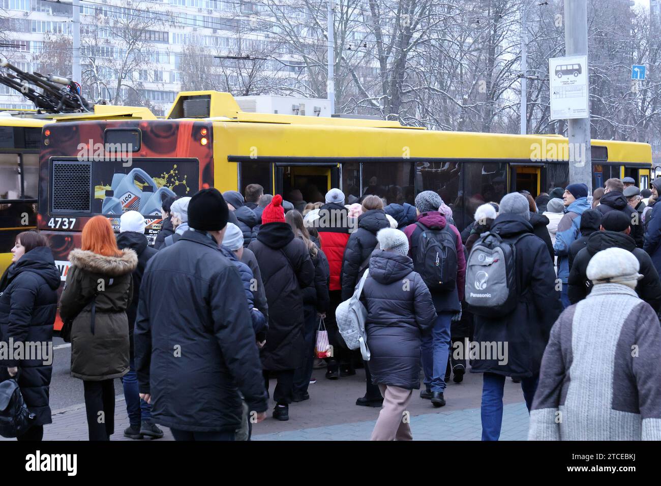 KYIV, UKRAINE - DECEMBER 12, 2023 - Passengers get on a bus at the ...