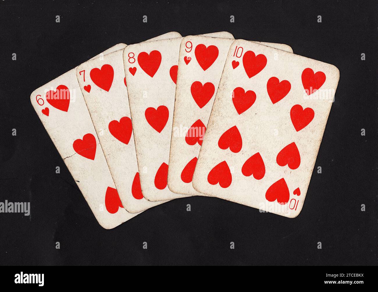 A poker hand of vintage playing cards showing a straight flush of ...