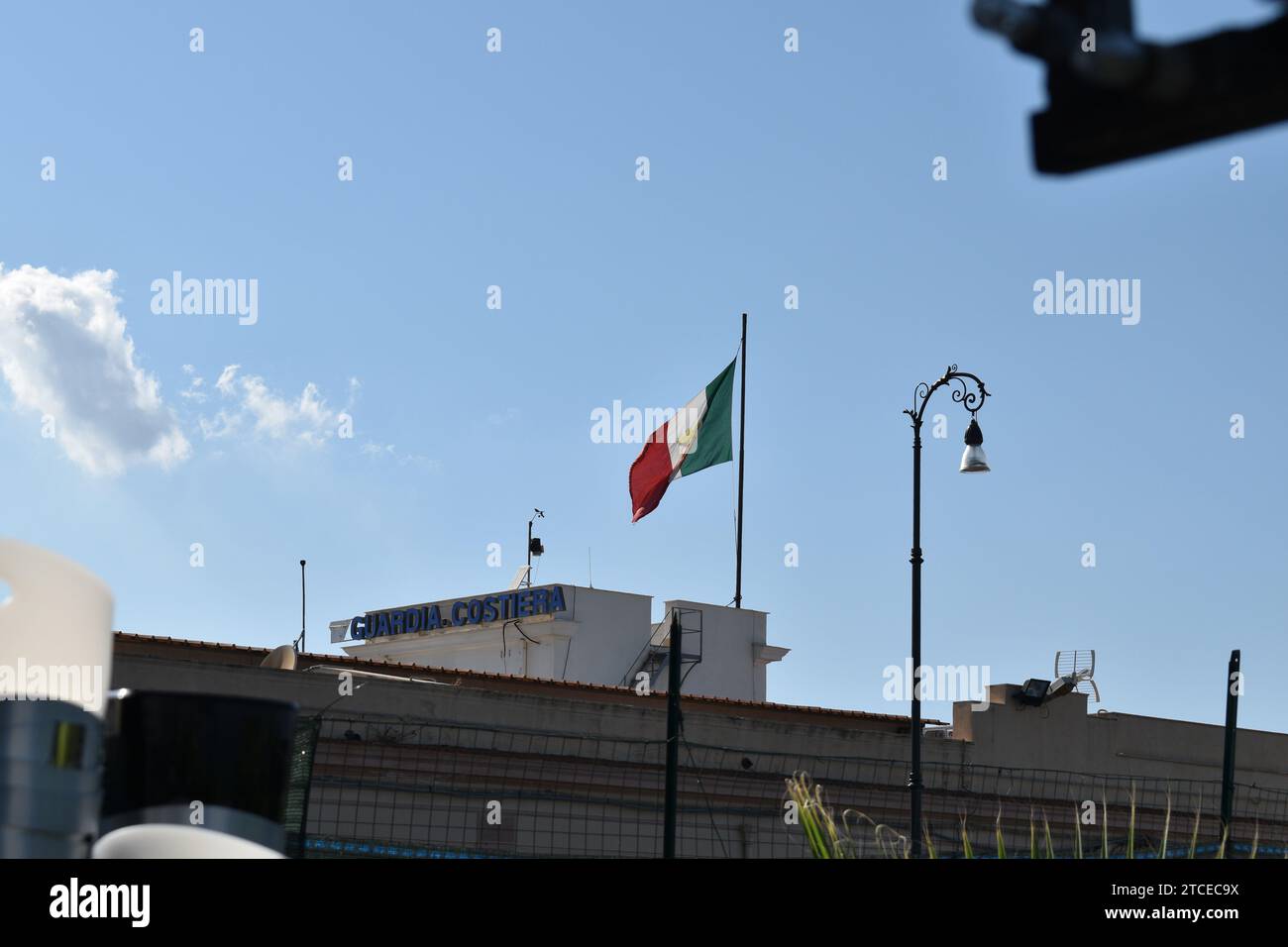 Waving Italian flag on the coast guard building in the port of Palermo ...