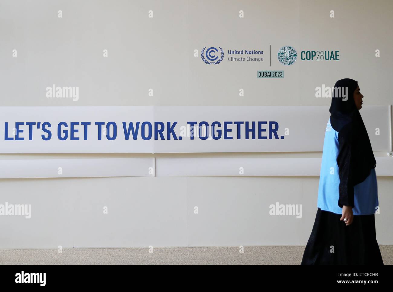 Dubai, United Arab Emirates. 12th Dec, 2023. An attendee walks in the ...