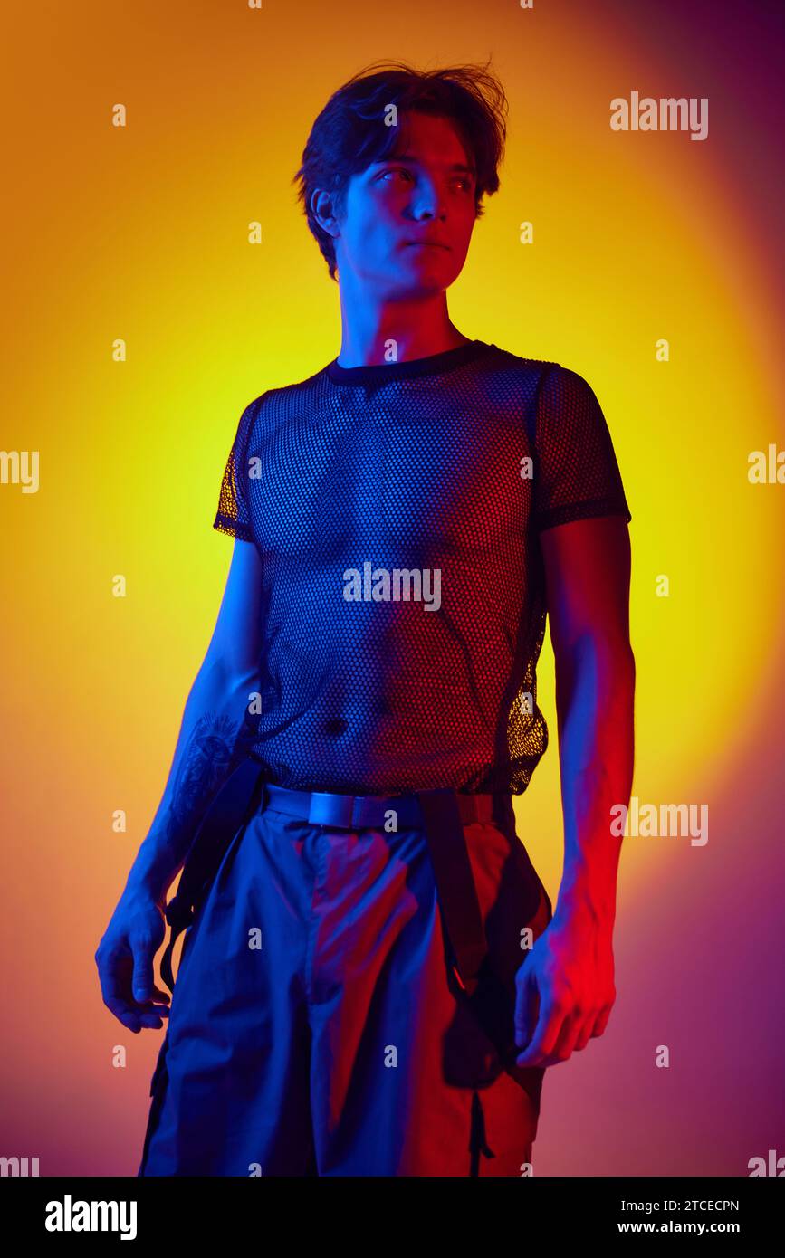 Handsome muscular young man in stylish extraordinary clothes posing ...