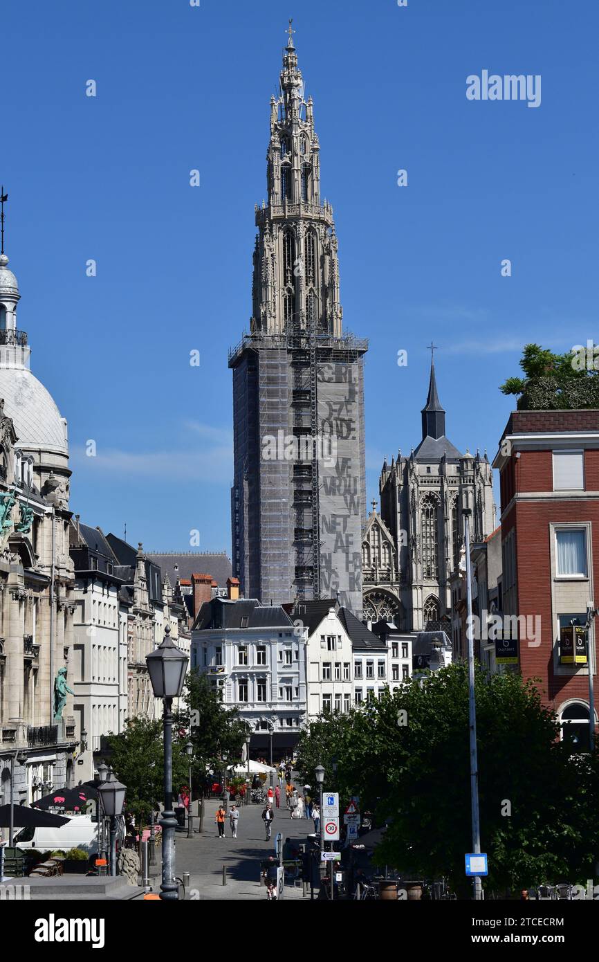 Majestic tower of the Antwerp cathedral towering over the houses and ...