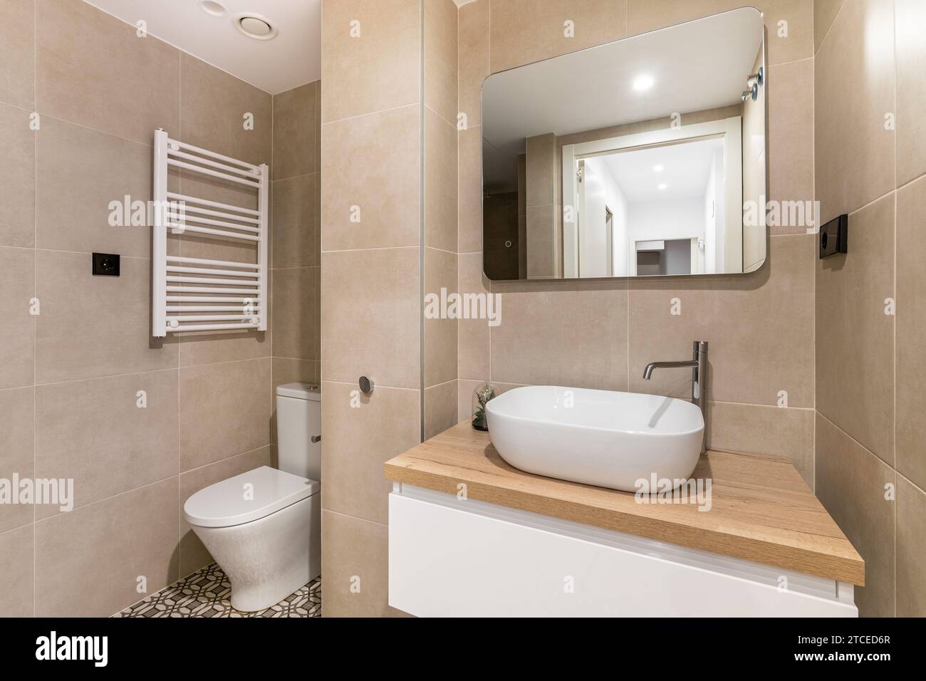 Sink with tap and mirror over chest of drawers in bathroom Stock Photo ...