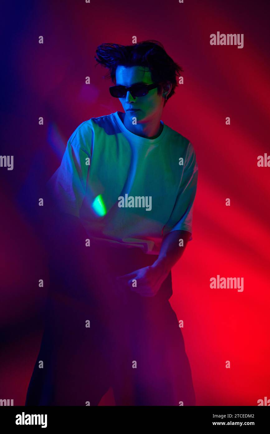 Handsome stylish young guy in white t-shirt and sunglasses posing over ...