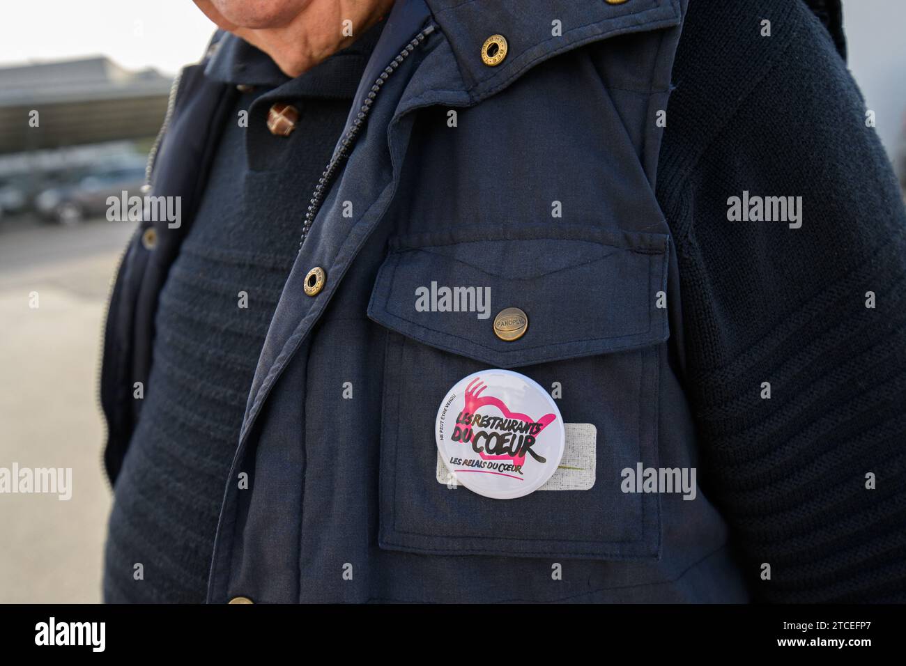 A retired volunteer wears his badge on his jacket in the Restaurants du ...