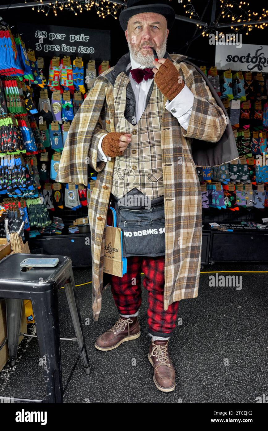 Victorian street market festival with market trader in traditional ...