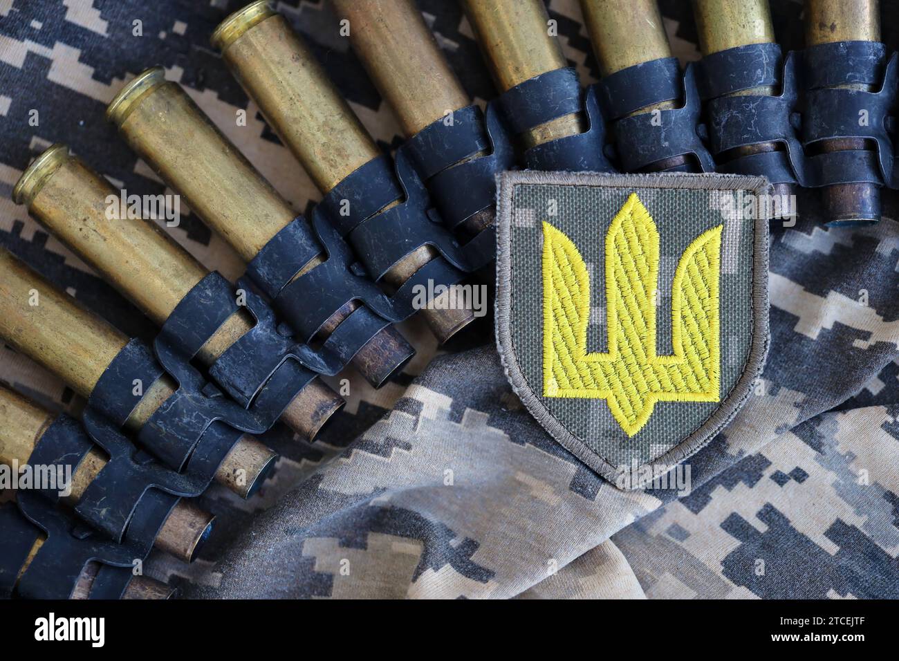 Ukrainian army symbol on machine gun belt lies on ukrainian pixeled ...