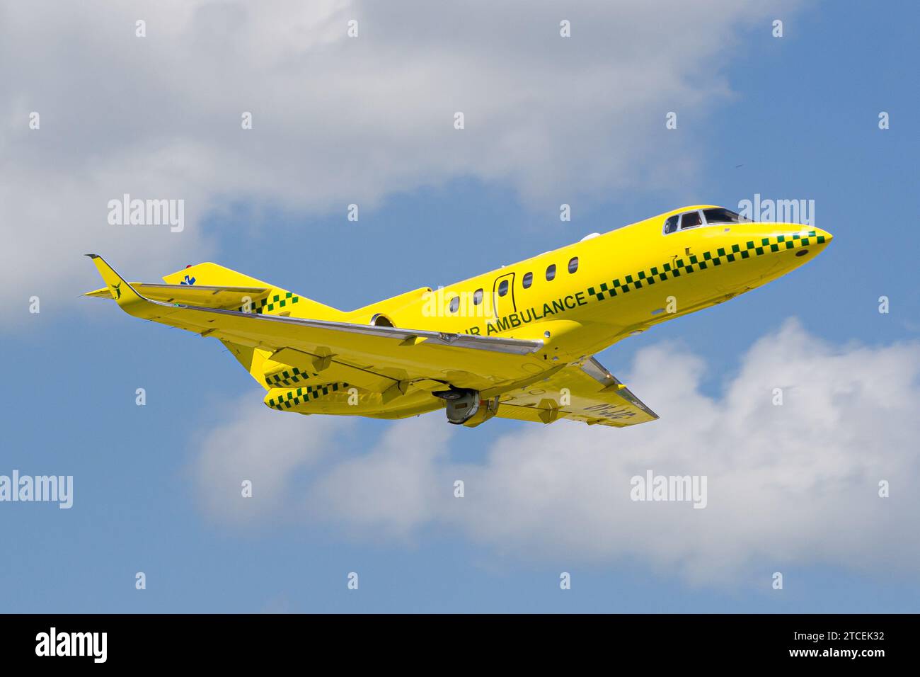 Private yellow Air Ambulance aircraft taking off, retracting its gear ...