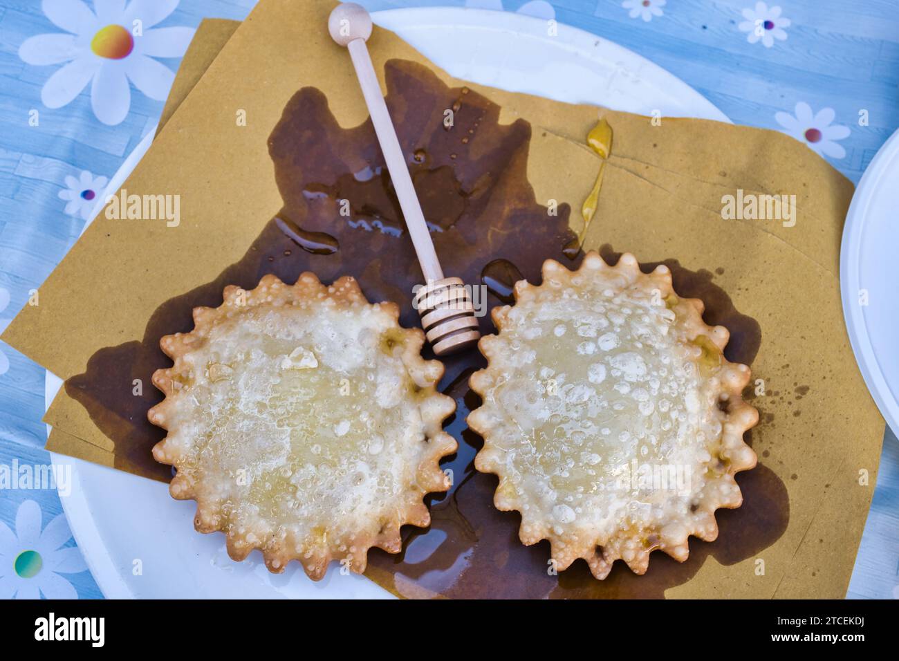 Close top view of two sebadas with honey, a typical sardinian dessert ...