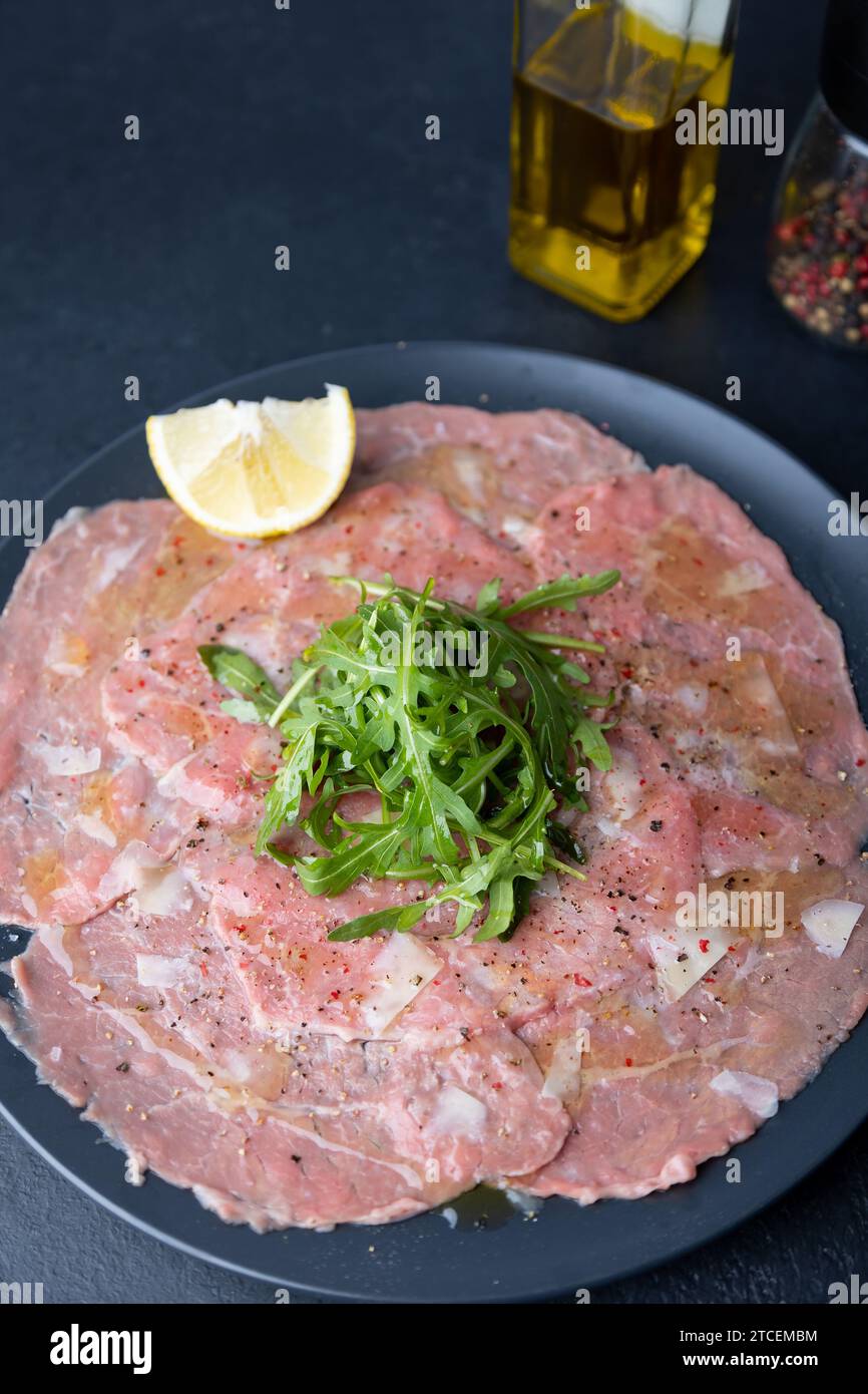 Marbled beef carpaccio with arugula, parmesan cheese, olive oil and ...