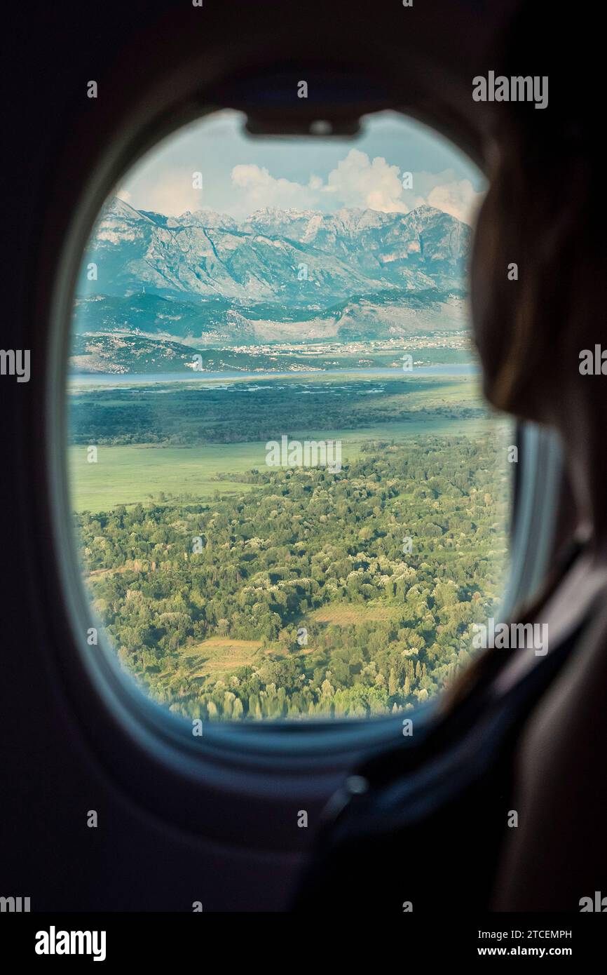 Women looking throw teh window in airplane, during landing in ...