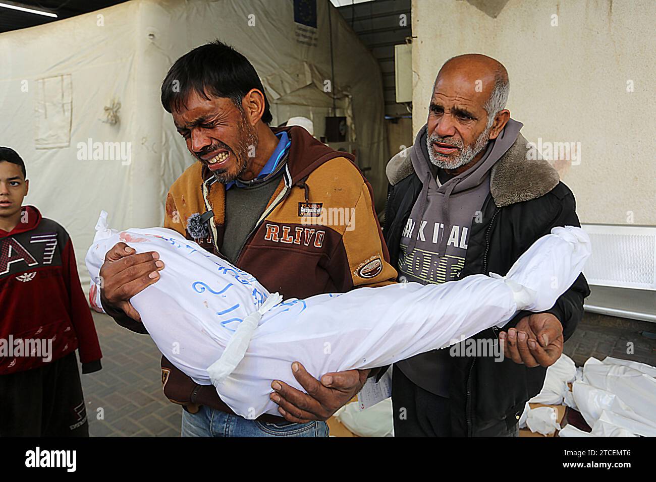 Rafah, Gaza. 12th Dec, 2023. A Palestinian man mourns the death of this ...