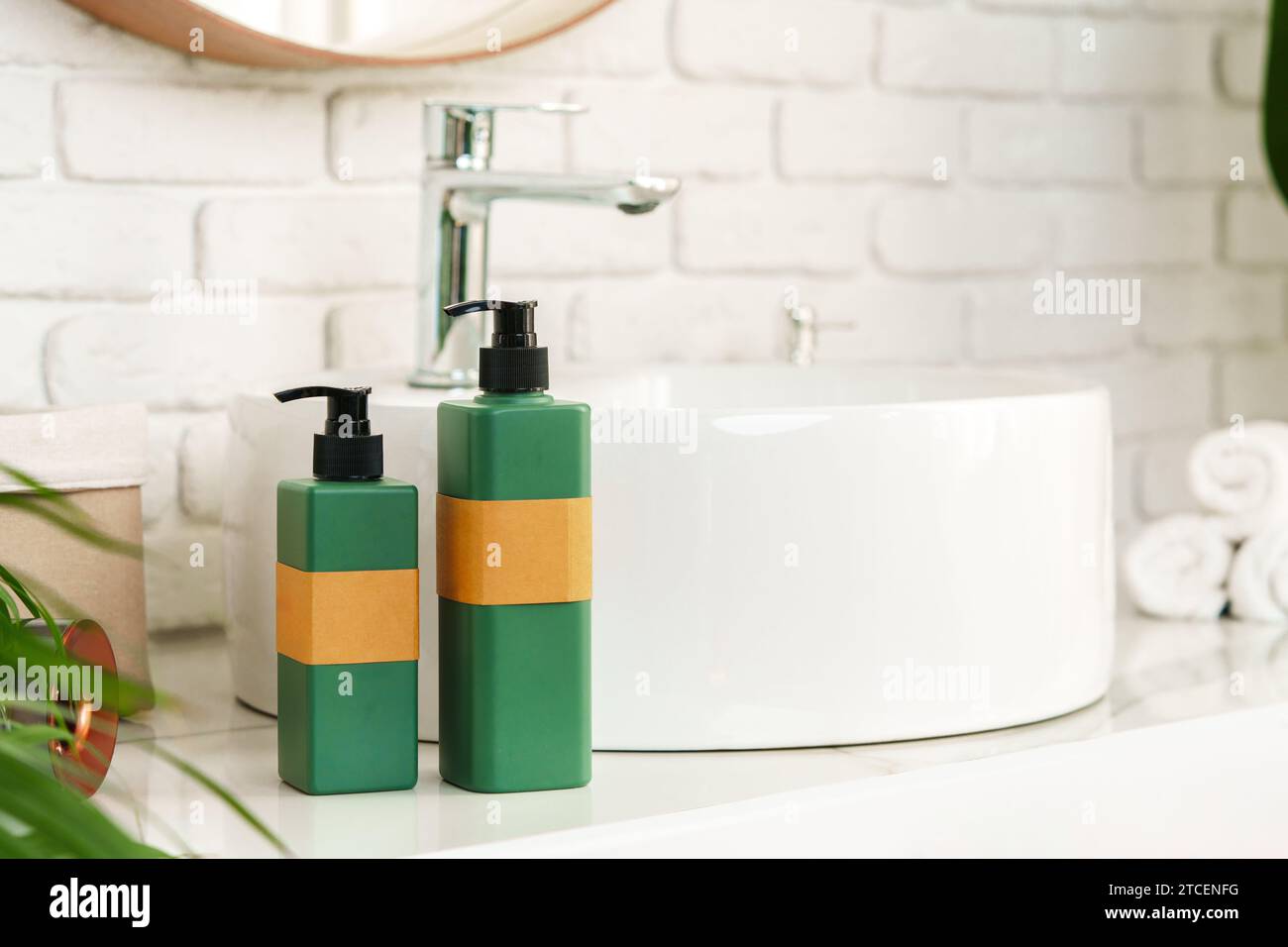 Soap and cream dispenser jars near the sink in a bathroom Stock Photo ...