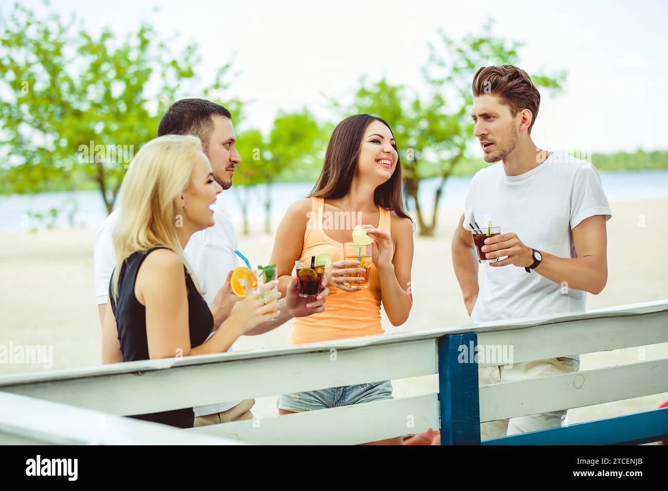 Friends having fun at the bar outdoors, drinking cocktails Stock Photo ...