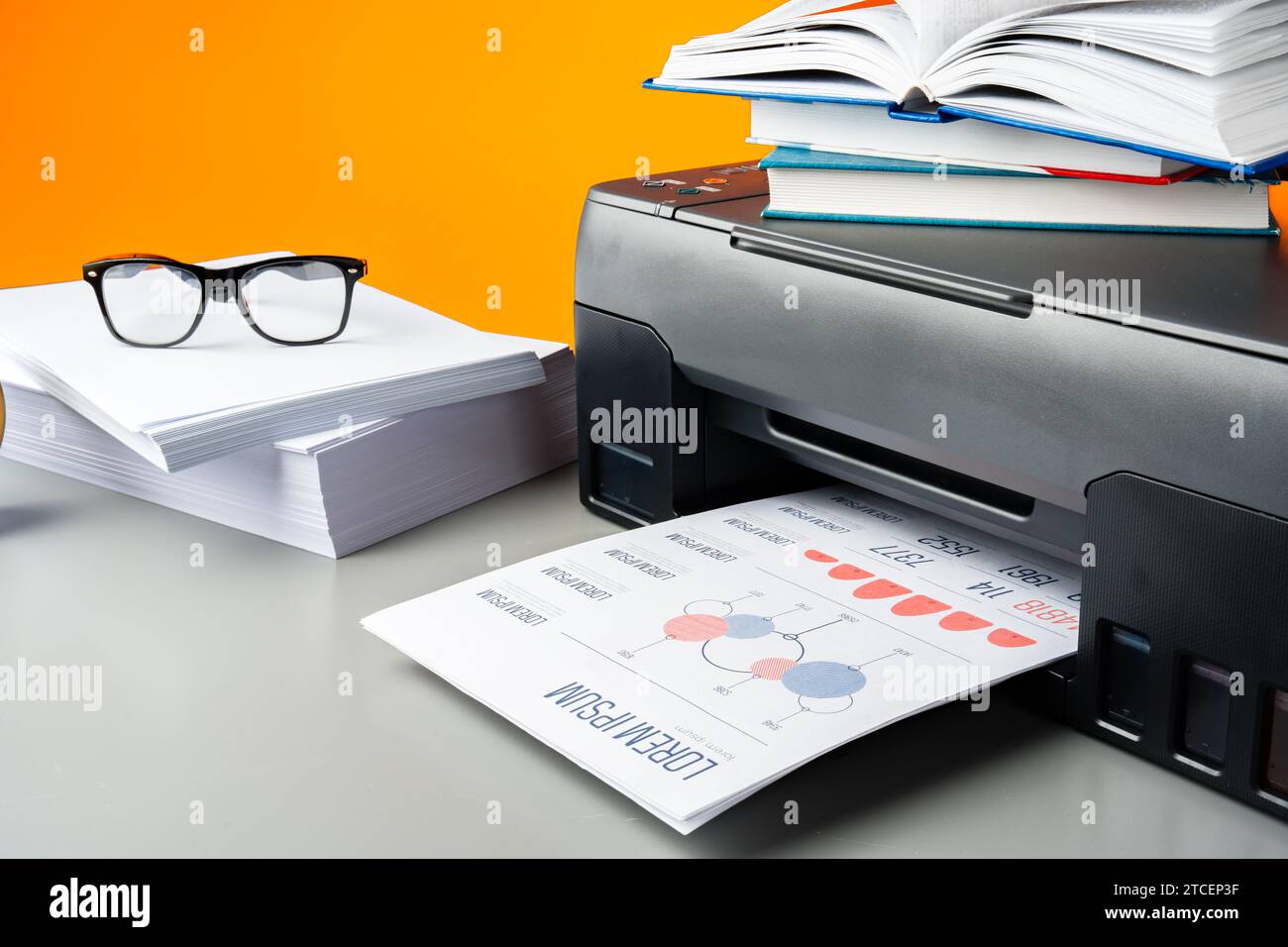 Laser printer on desk against yellow background Stock Photo - Alamy