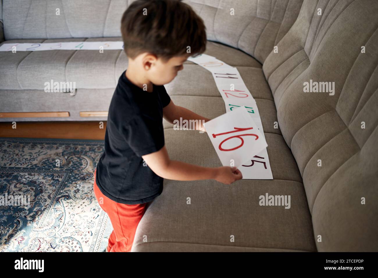 A boy with autism puts numbers in order Stock Photo - Alamy