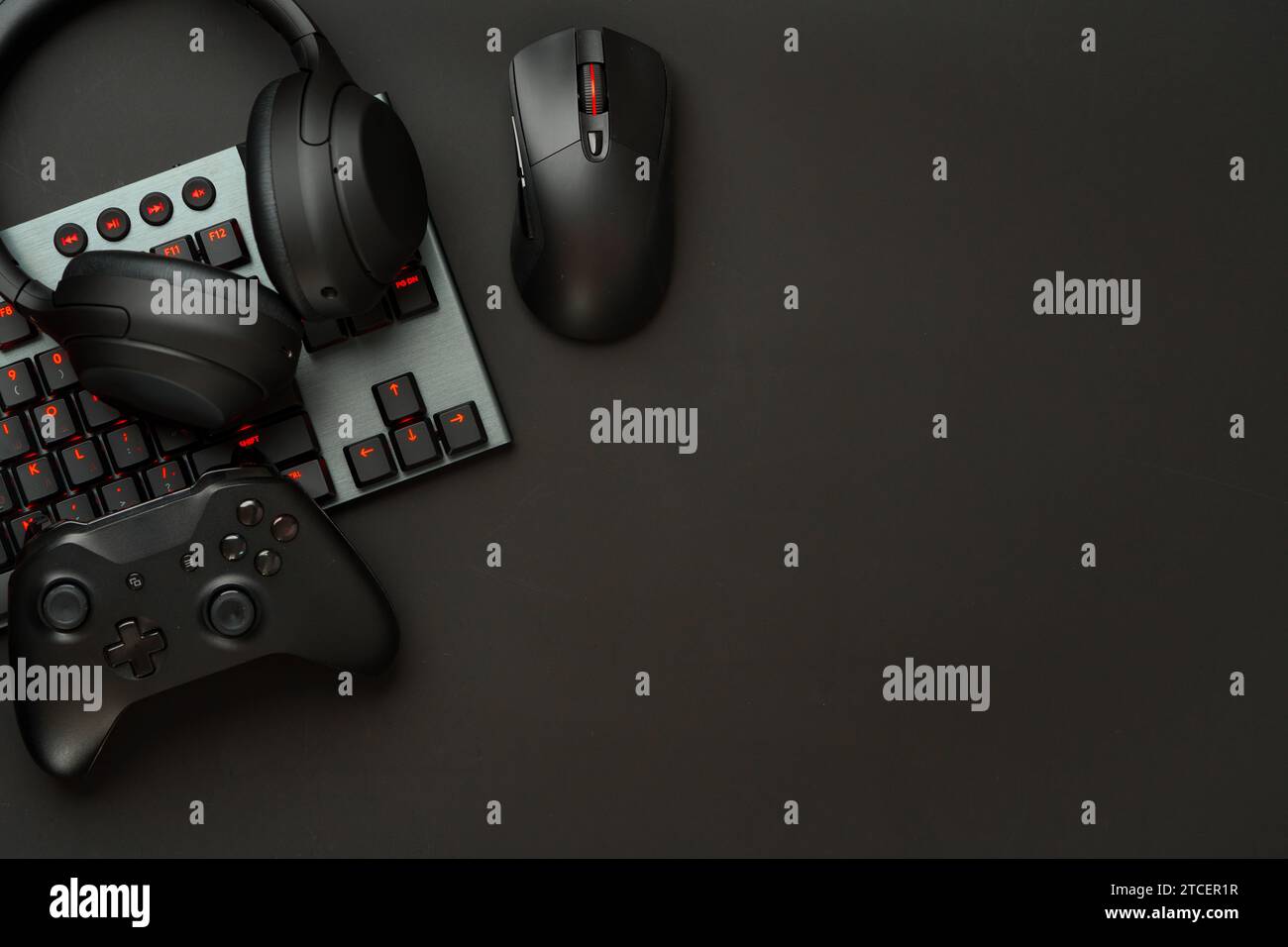 Gaming concept on black background with computer keyboard and joystick ...