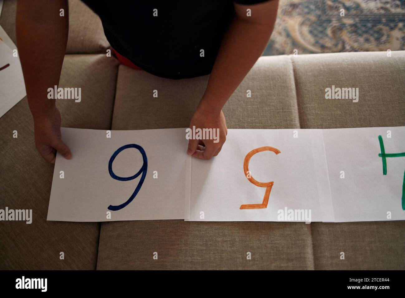 Children's hands arrange numbers in order on the sofa. Close-up Stock ...