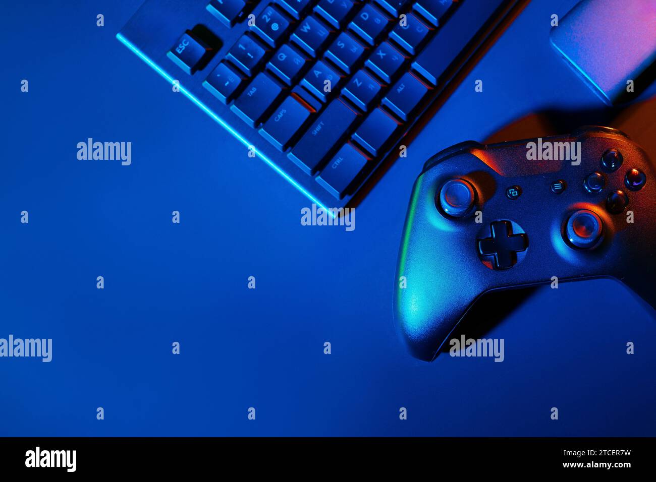 Gaming concept on black background with computer keyboard and joystick ...