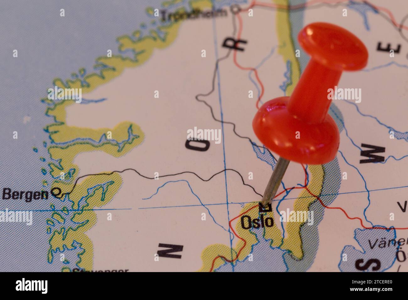A red pin stuck into a map of Western Europe, pinpointing the location ...