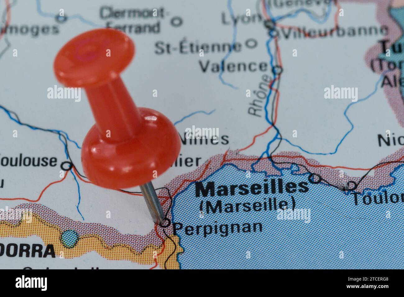 A red pin stuck into a map of Western Europe, pinpointing the location ...