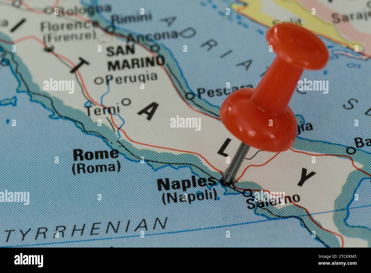 A red pin stuck into a map of Western Europe, pinpointing the location ...