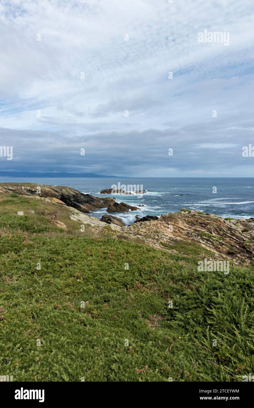 scenic coastal landscape with rocky terrain, green vegetation, and a ...