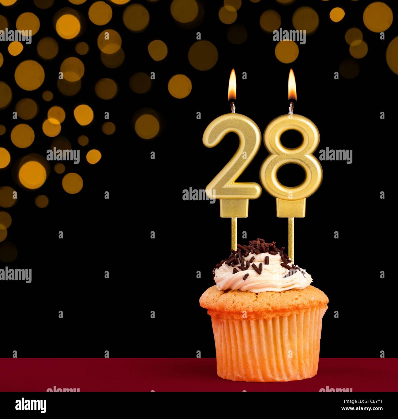 Birthday candle with cupcake - Number 28 on black background with out ...