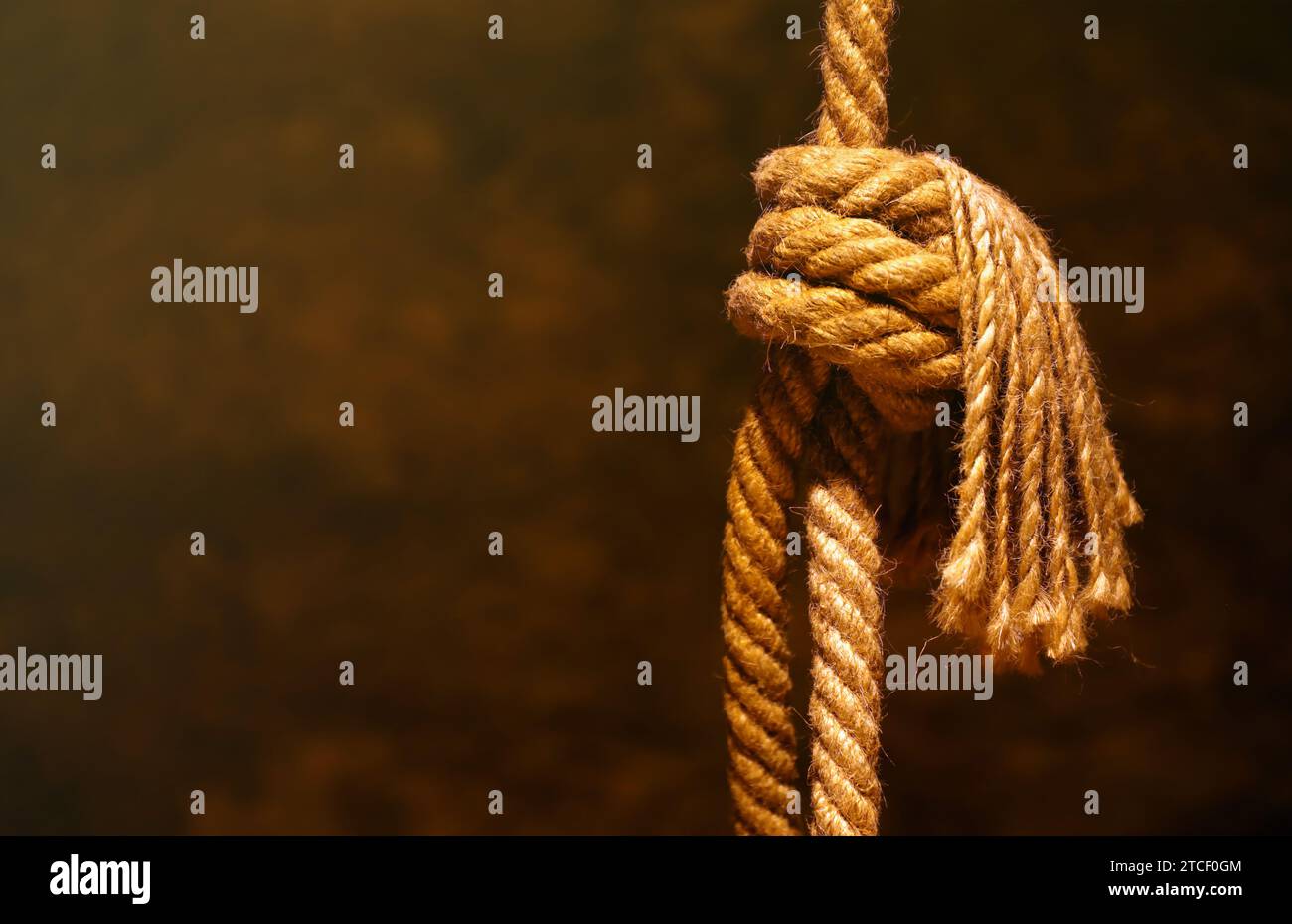 Noose in prison of old castle cellar and grunge stone wall close up ...