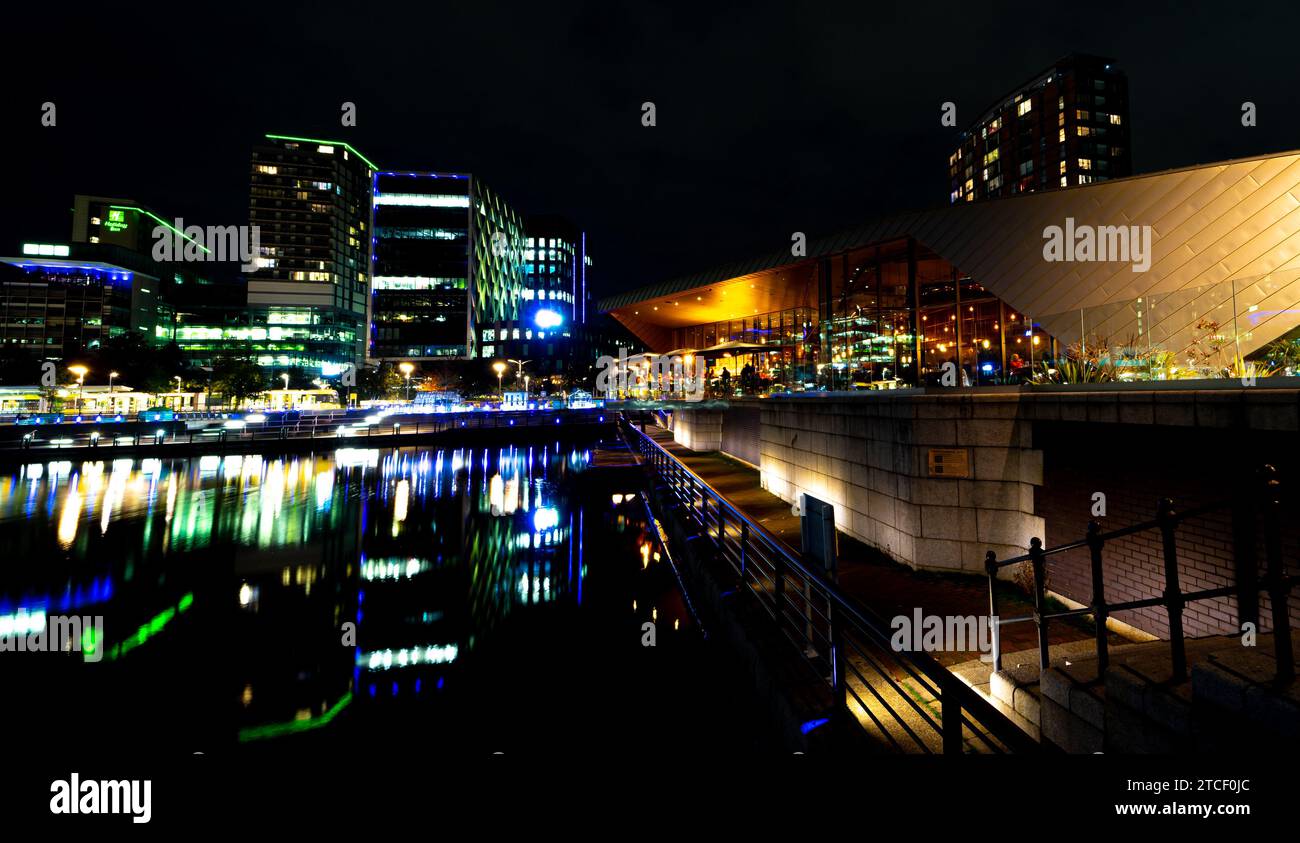 Media City, Manchester. Reflections of the buildings lit up at night in the quay Stock Photo - Alamy