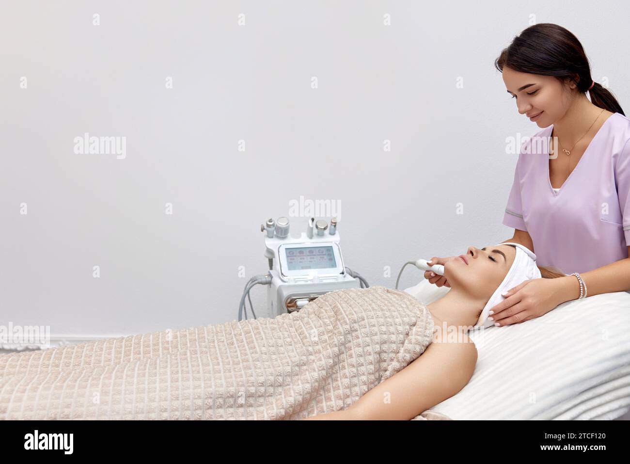 cosmetologist doing peeling procedure for female client in beauty salon ...