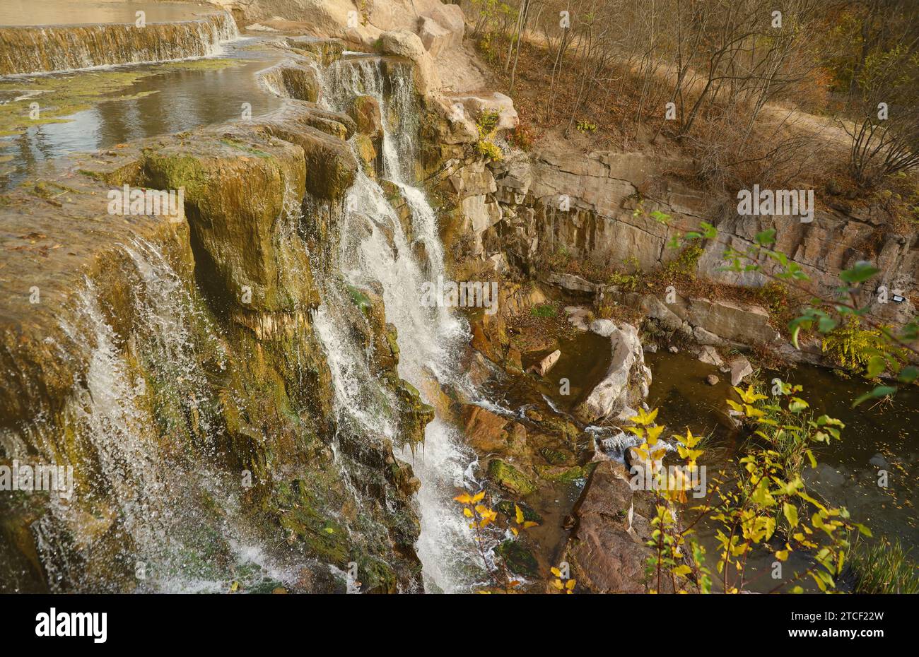 Beautiful waterfall between large rocks in the autumn forest ...