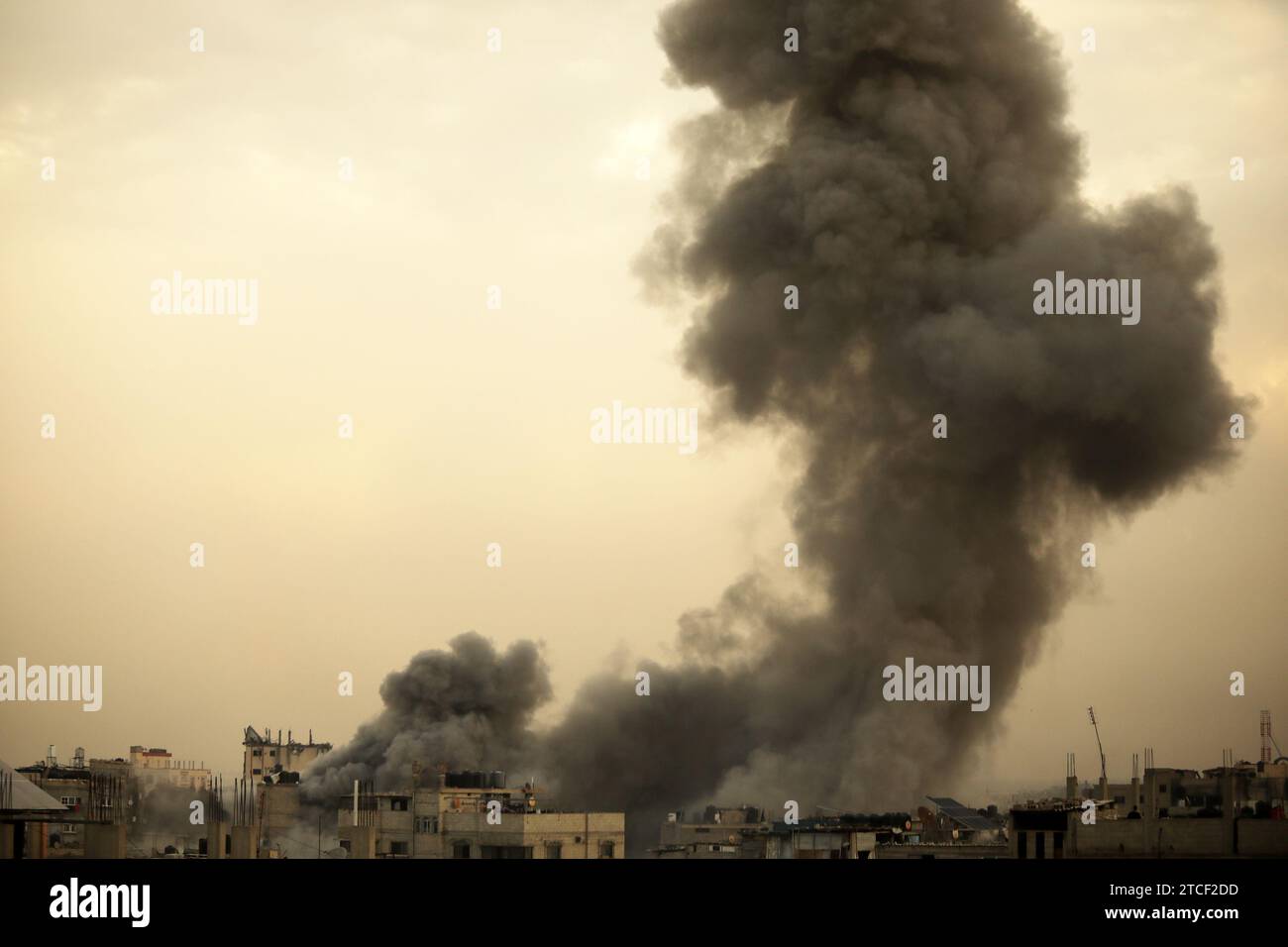 Rafah, Gaza. 12th Dec, 2023. A smoke plume erupts during Israeli ...
