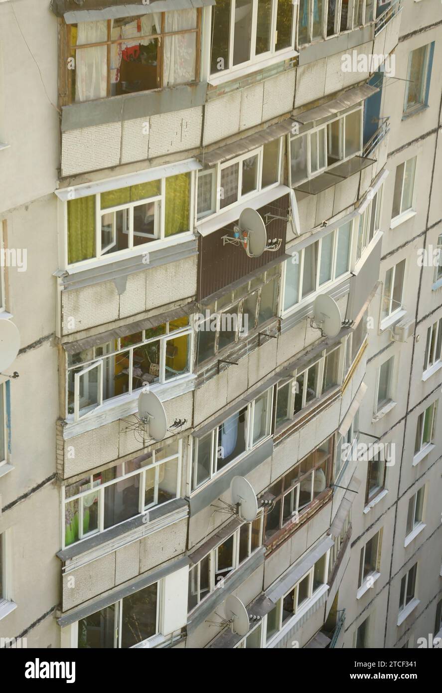 Facade of a grey multi storey soviet panel building. Russian old urban ...