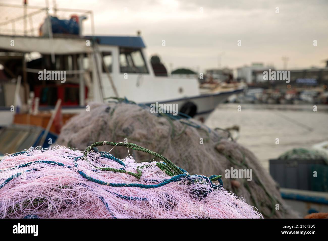 fishing net in front, fishing boat in the background Stock Photo - Alamy
